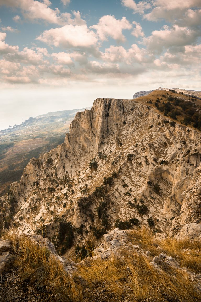 High angle photo of a brown cliff under white clouds | Pixeor – Large ...